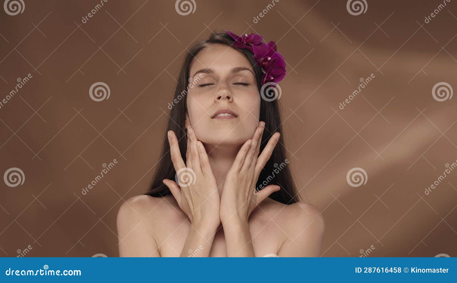 A Woman Strokes The Skin Of Her Face Neck And Shoulders Enjoying Her