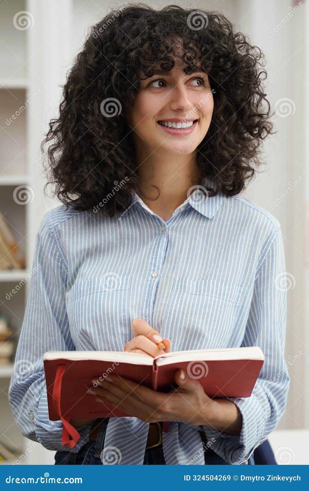 Woman Student Writing in Her Organizer Preparing for Classes in ...