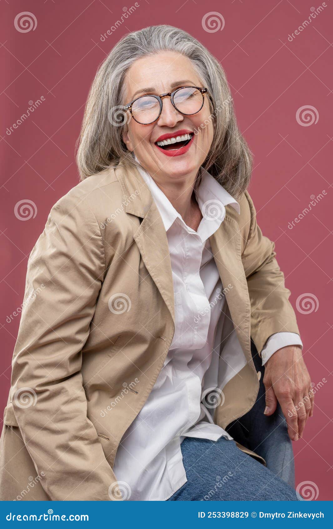 Good-looking Mid Aged Woman in a Beige Jacket Looking at the Camera ...