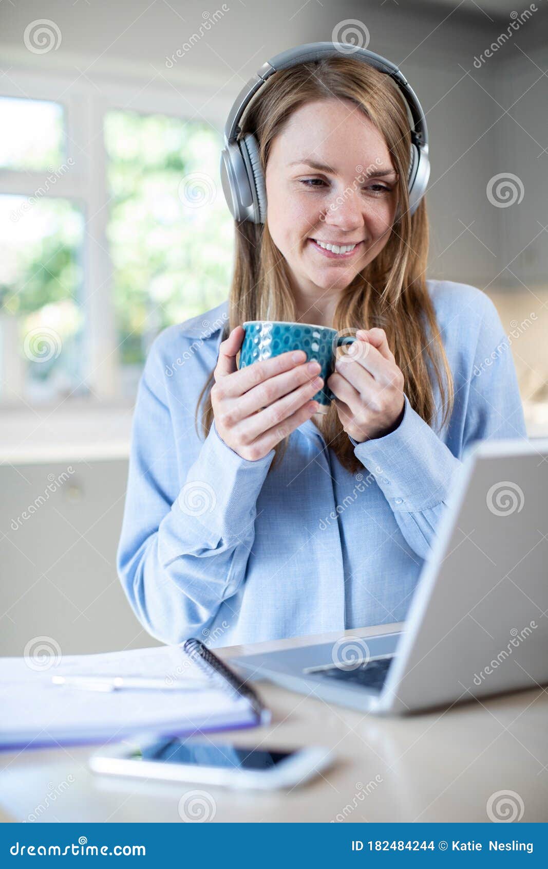 Woman Studying at Home Using Laptop and Wearing Headphones Stock Photo ... Woman Studying at Home Using Laptop and Wearing Headphones Stock Photo ...