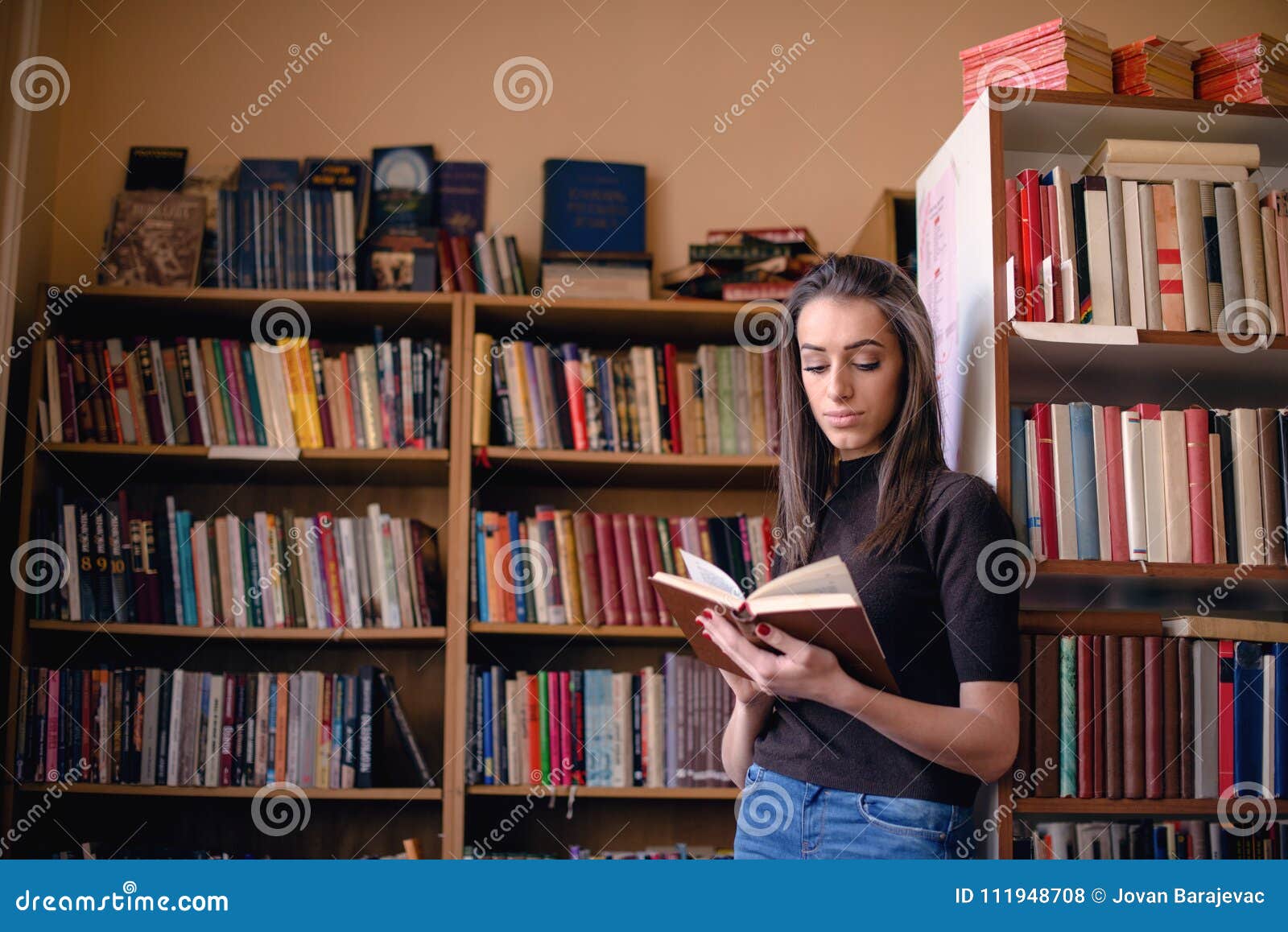 Woman studying in library stock photo. Image of holding - 111948708