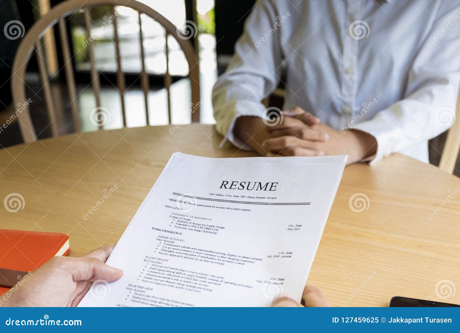 Woman Submits Job Application, Interviewer Reading a Resume. Stock ...