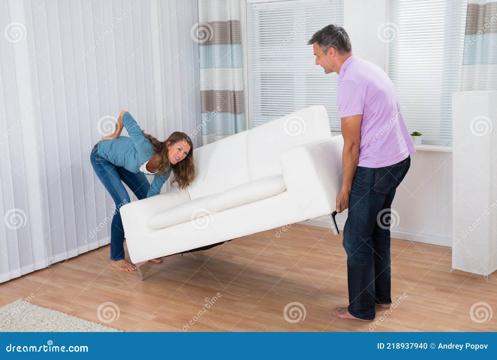 Woman Suffering from Backache while Moving Sofa Stock Photo - Image of ...