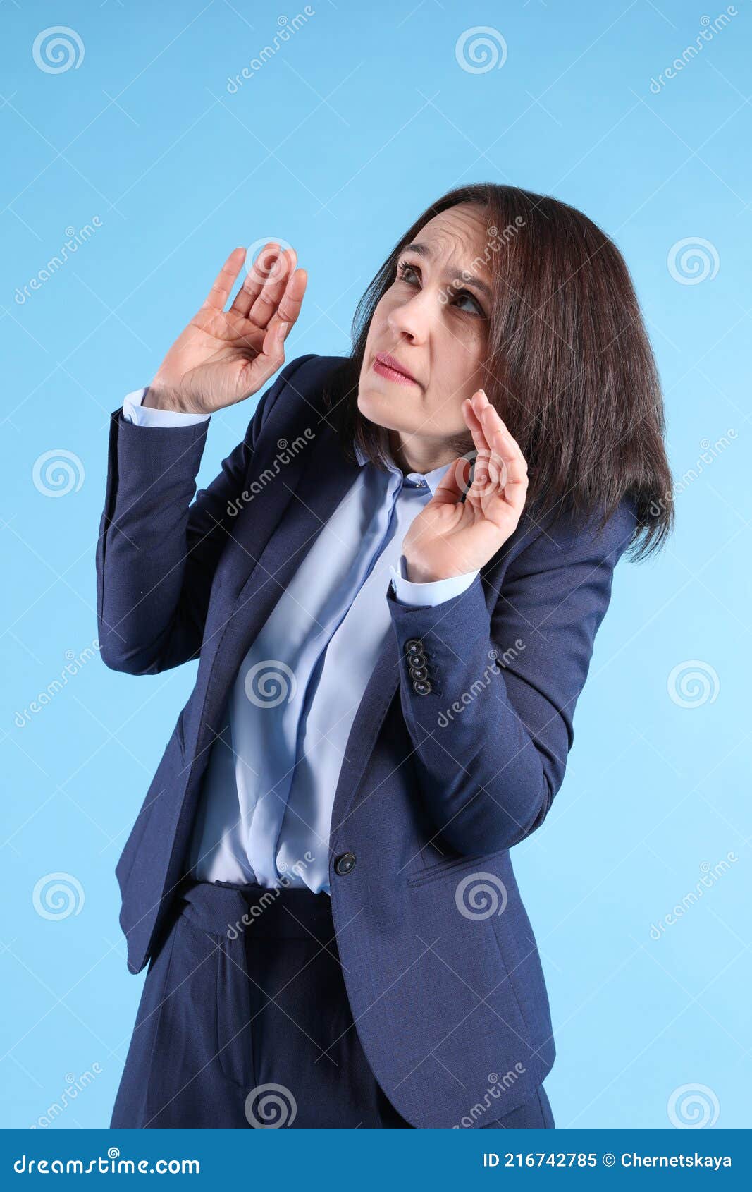 Woman in Suit Avoiding Something on Light Blue Background Stock Image ...