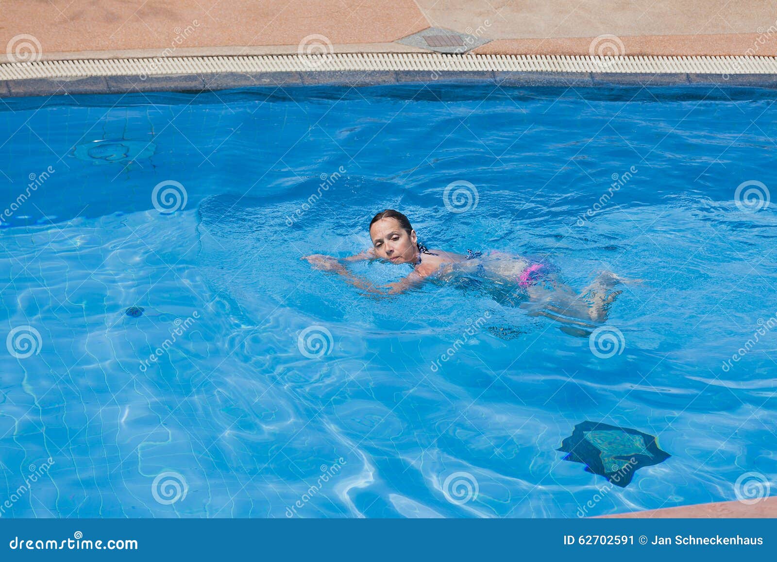 A woman swims alone stock image. Image of concentration - 62702591