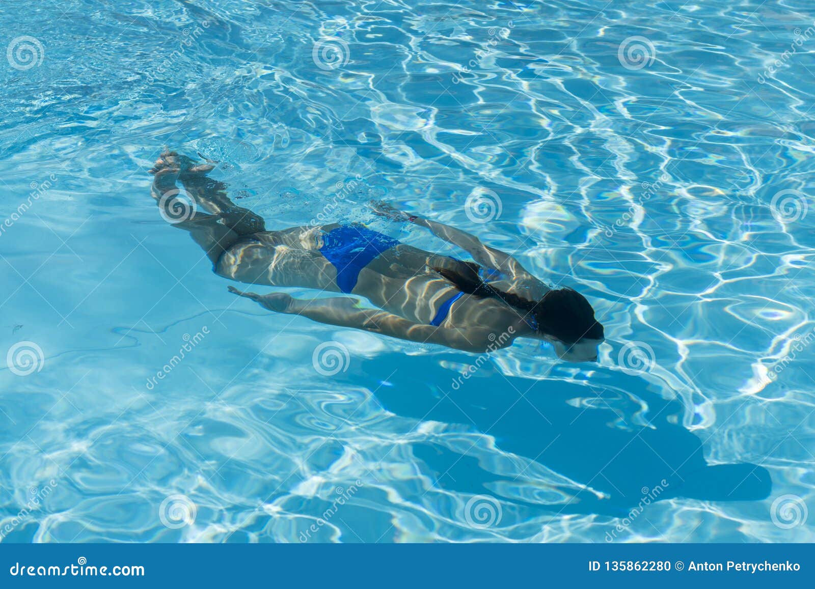 Woman With Swimsuit Swimming On A Blue Water Pool Underwater Woman