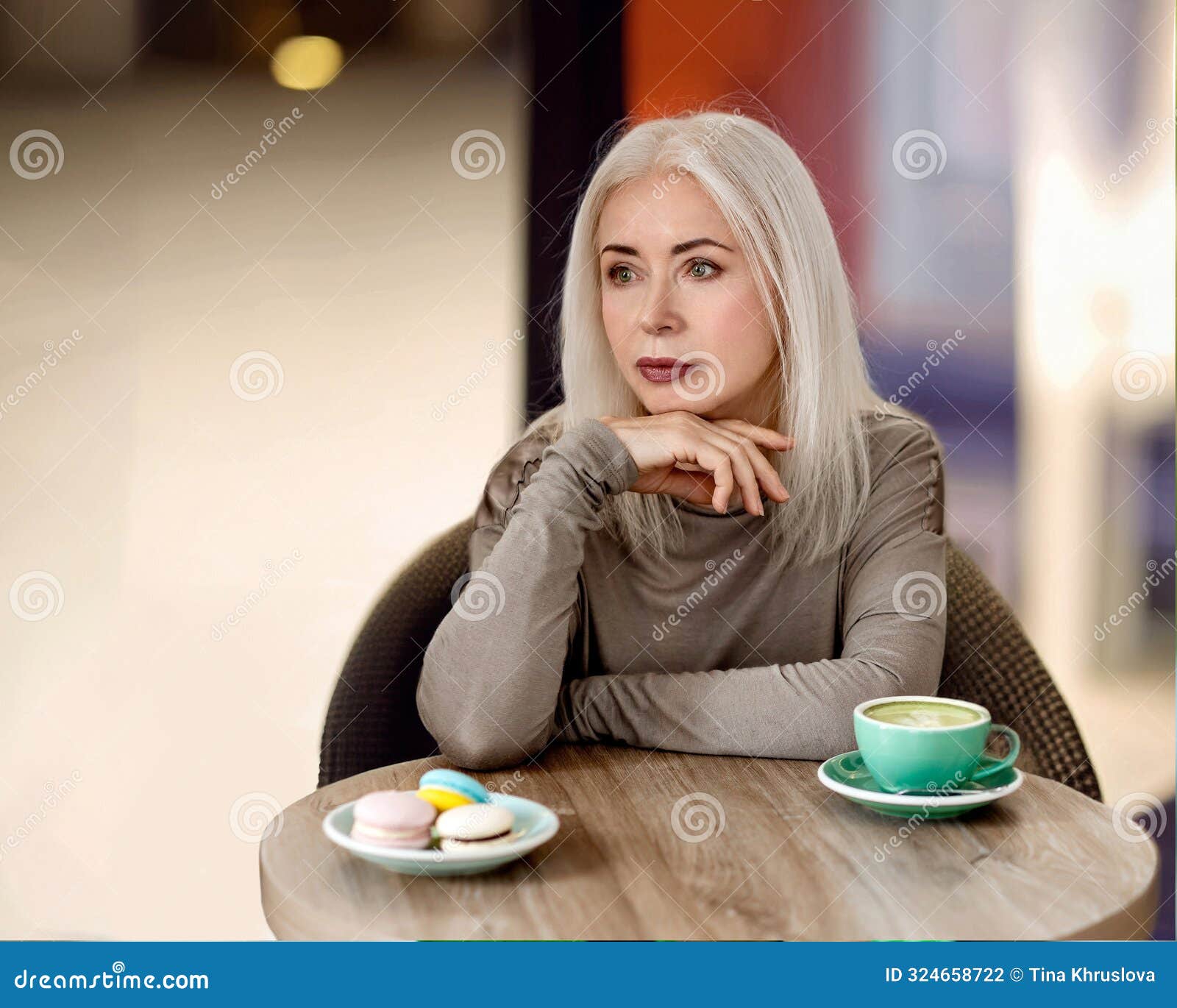 The Woman at the Table is Eating Breakfast at Home and Thinking about ...