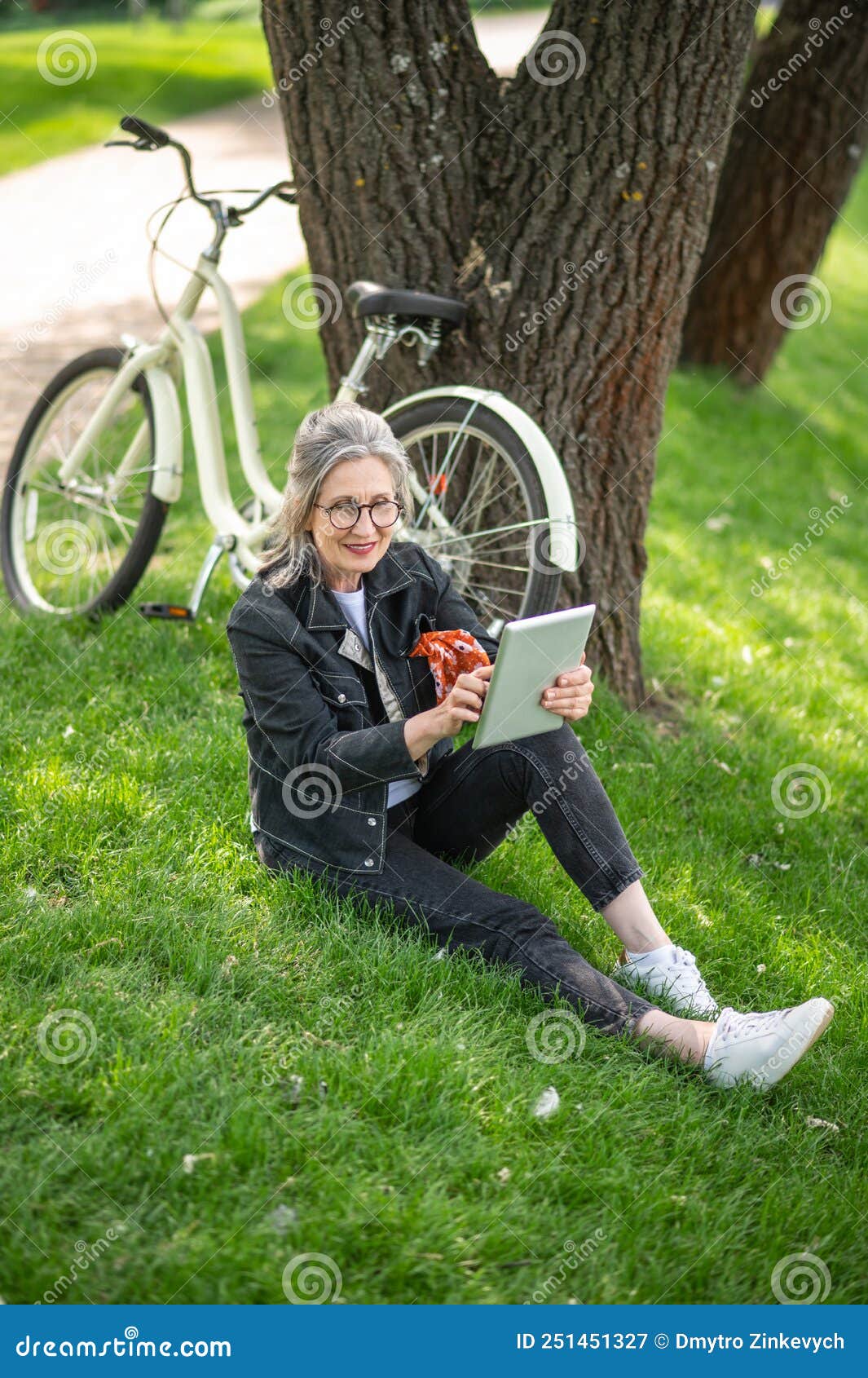 A Woman with a Tablet Sitting Near the River and Resting Stock Image ...