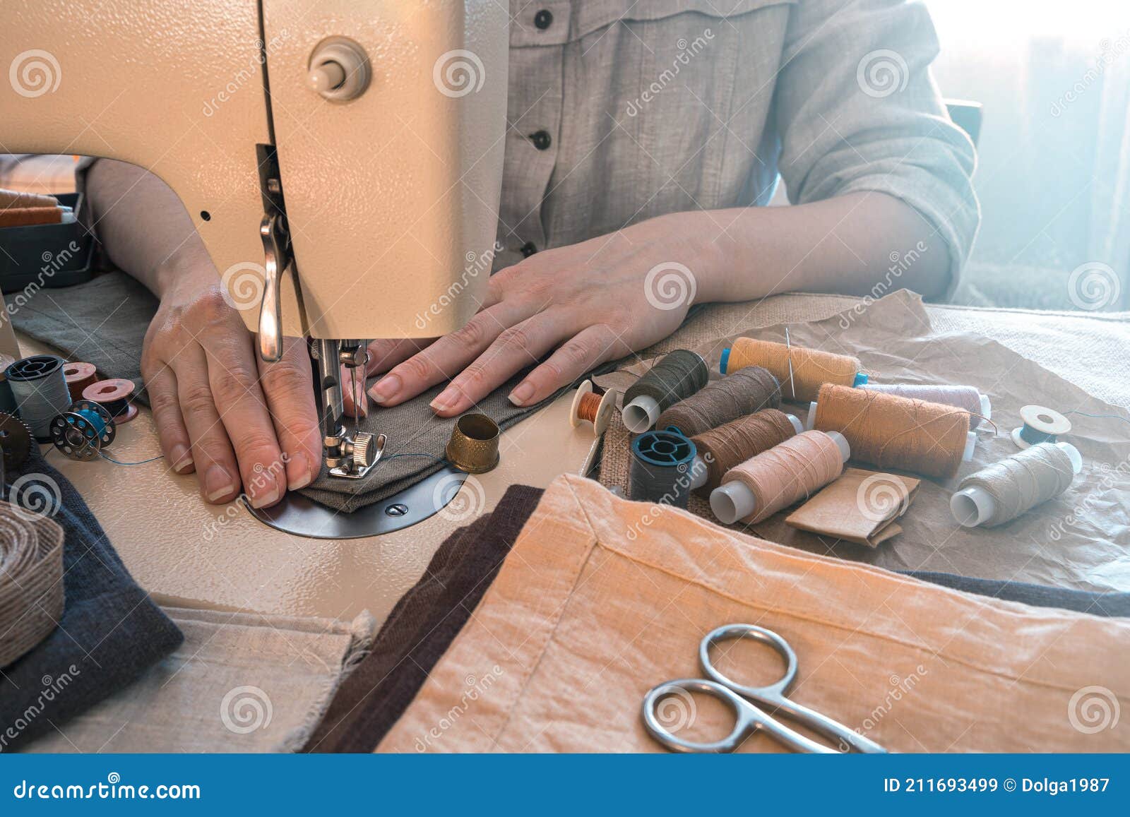 A Woman Tailor Sews on a Sewing Machine. Side View Stock Image - Image ...