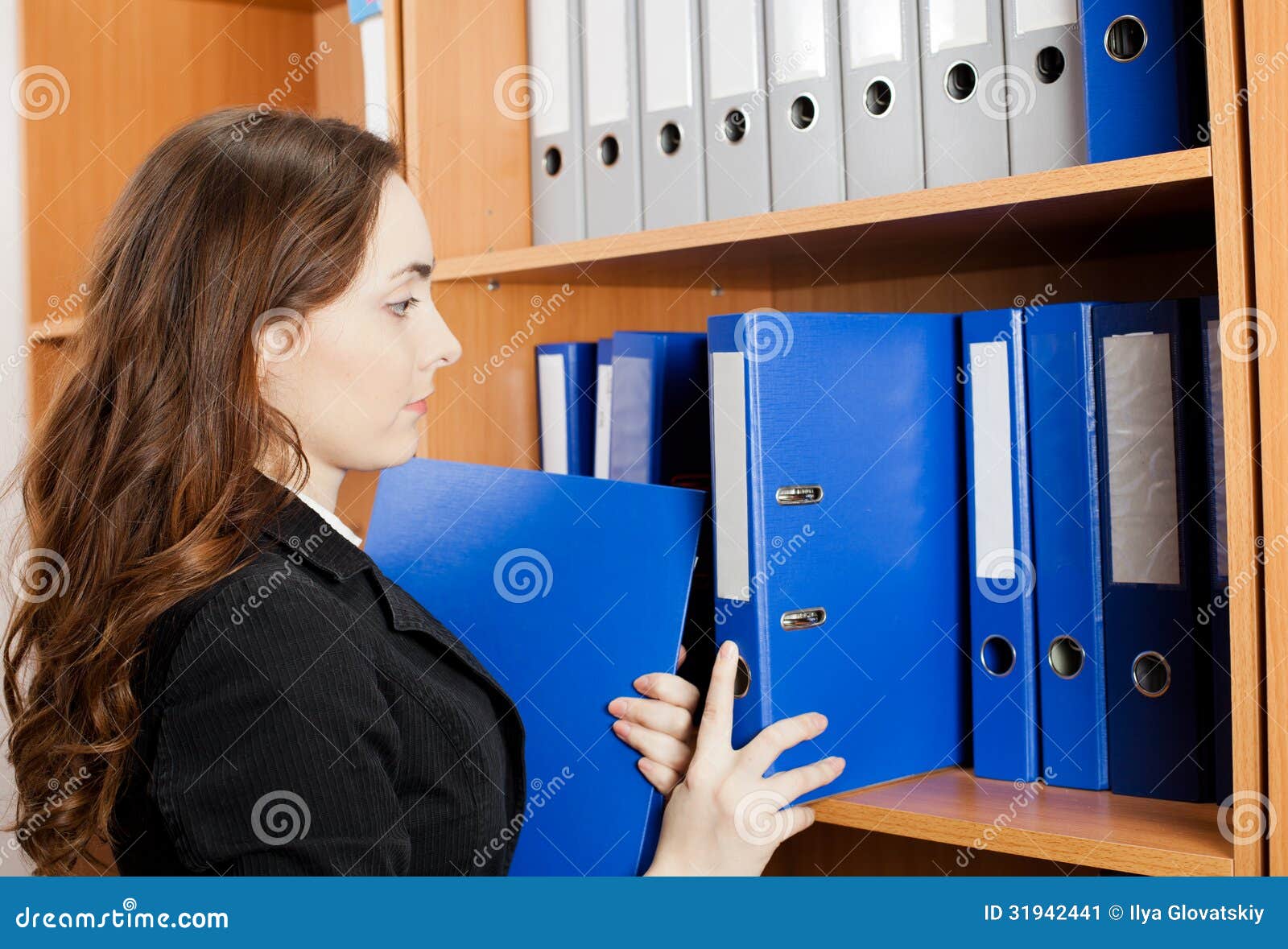 Woman Taking a Blue Folder from Shelf Stock Image - Image of indoors ...