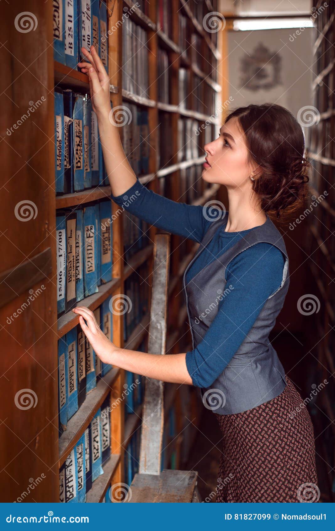 Woman Taking a Book from Bookshelf. Stock Image - Image of library ...