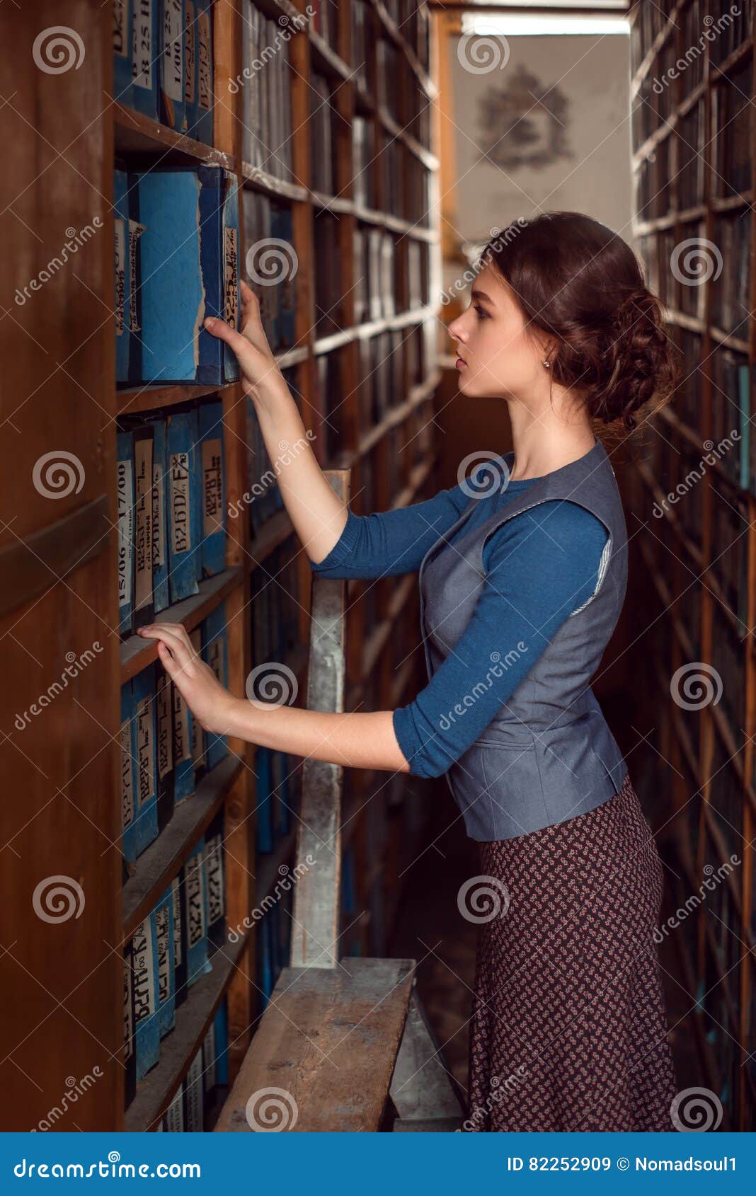 Woman Taking a Book from Bookshelf. Stock Image - Image of portrait ...