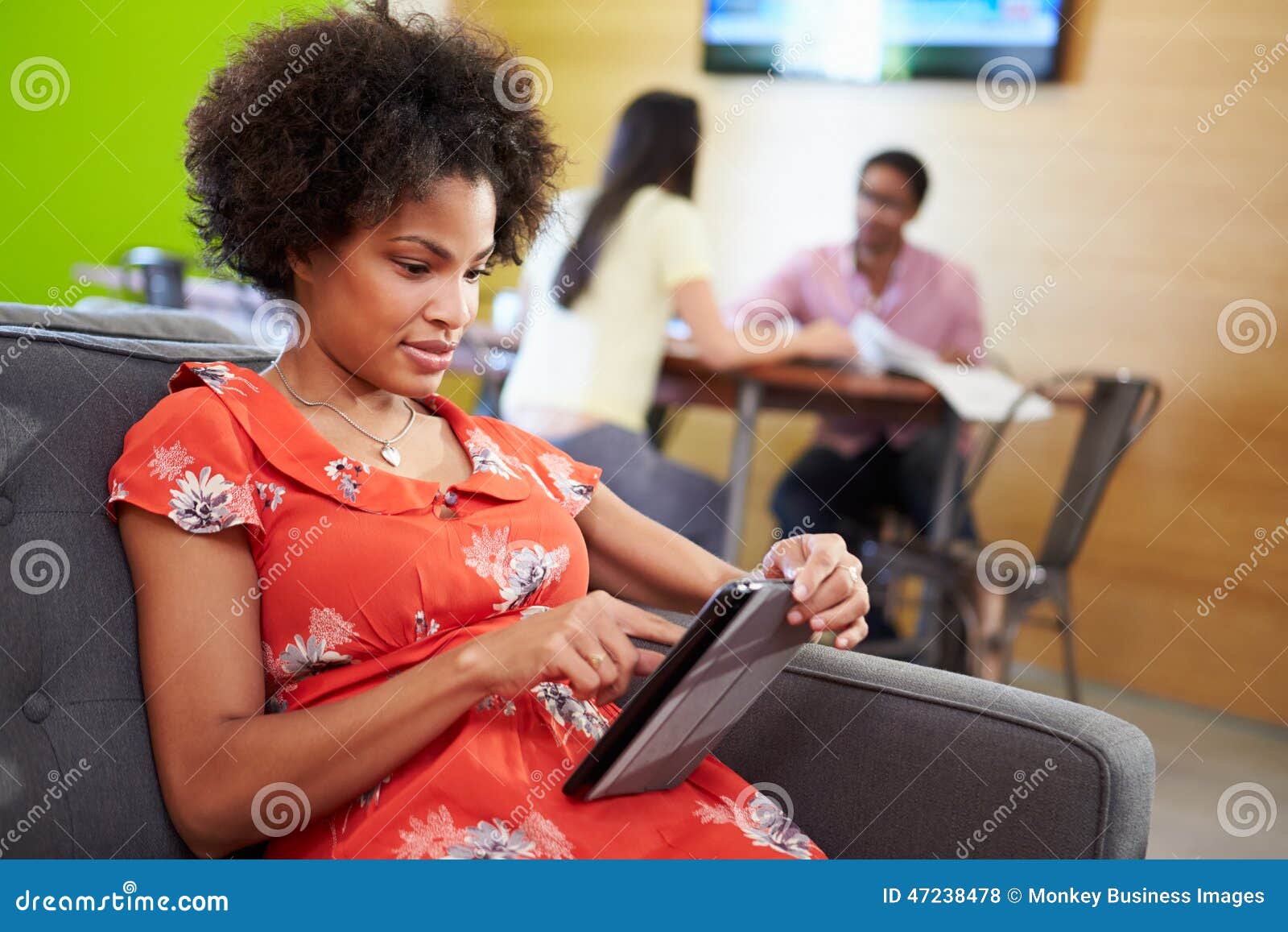 Woman Taking a Break Working on Sofa in Design Studio Stock Photo ...