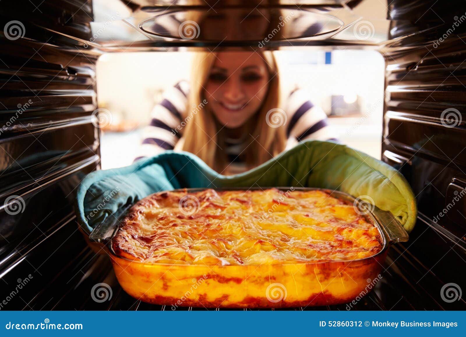 Woman Taking Cooked Dish of Lasagne Out of the Oven Stock Photo - Image ...