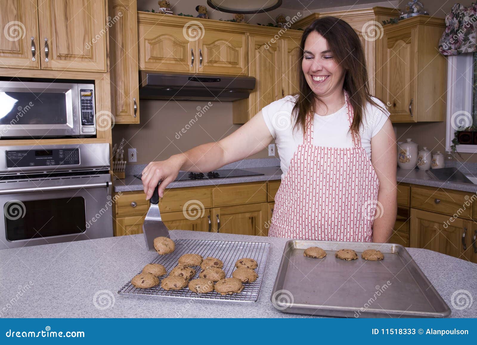 Woman Taking Cookies Off Pan Stock Image - Image of beautiful, hair ...