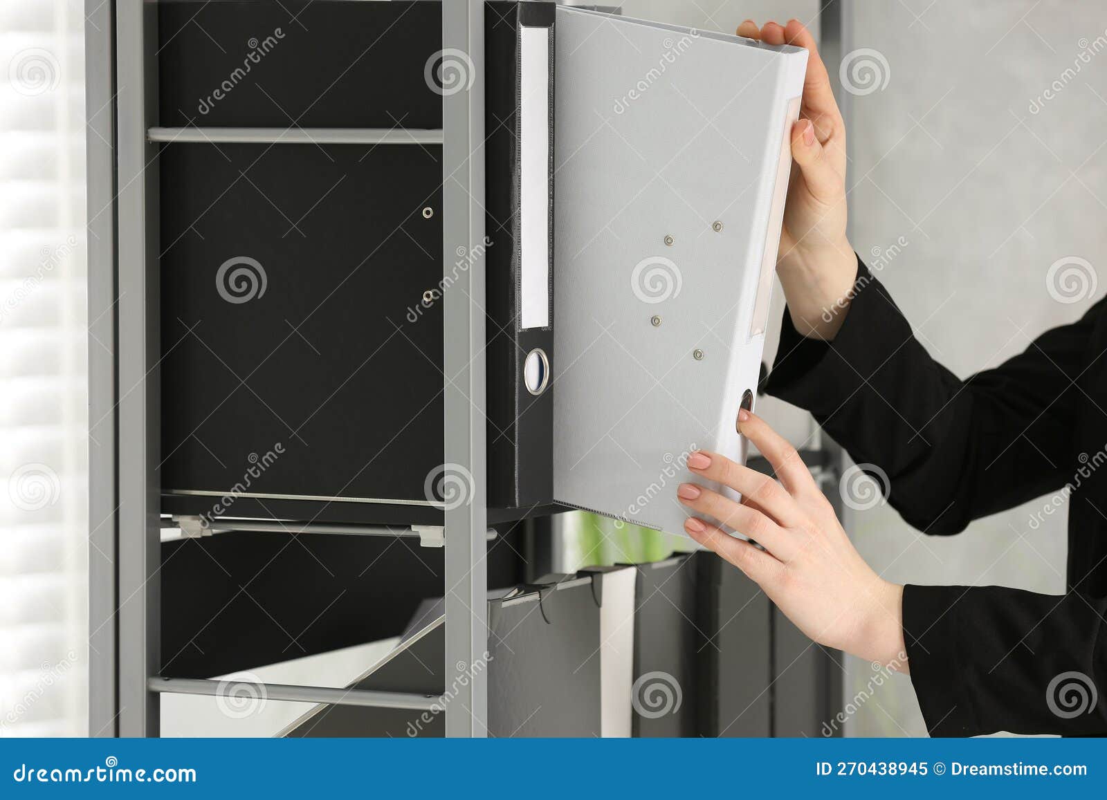 Woman Taking Folder with Documents from Shelf in Office, Closeup Stock ...