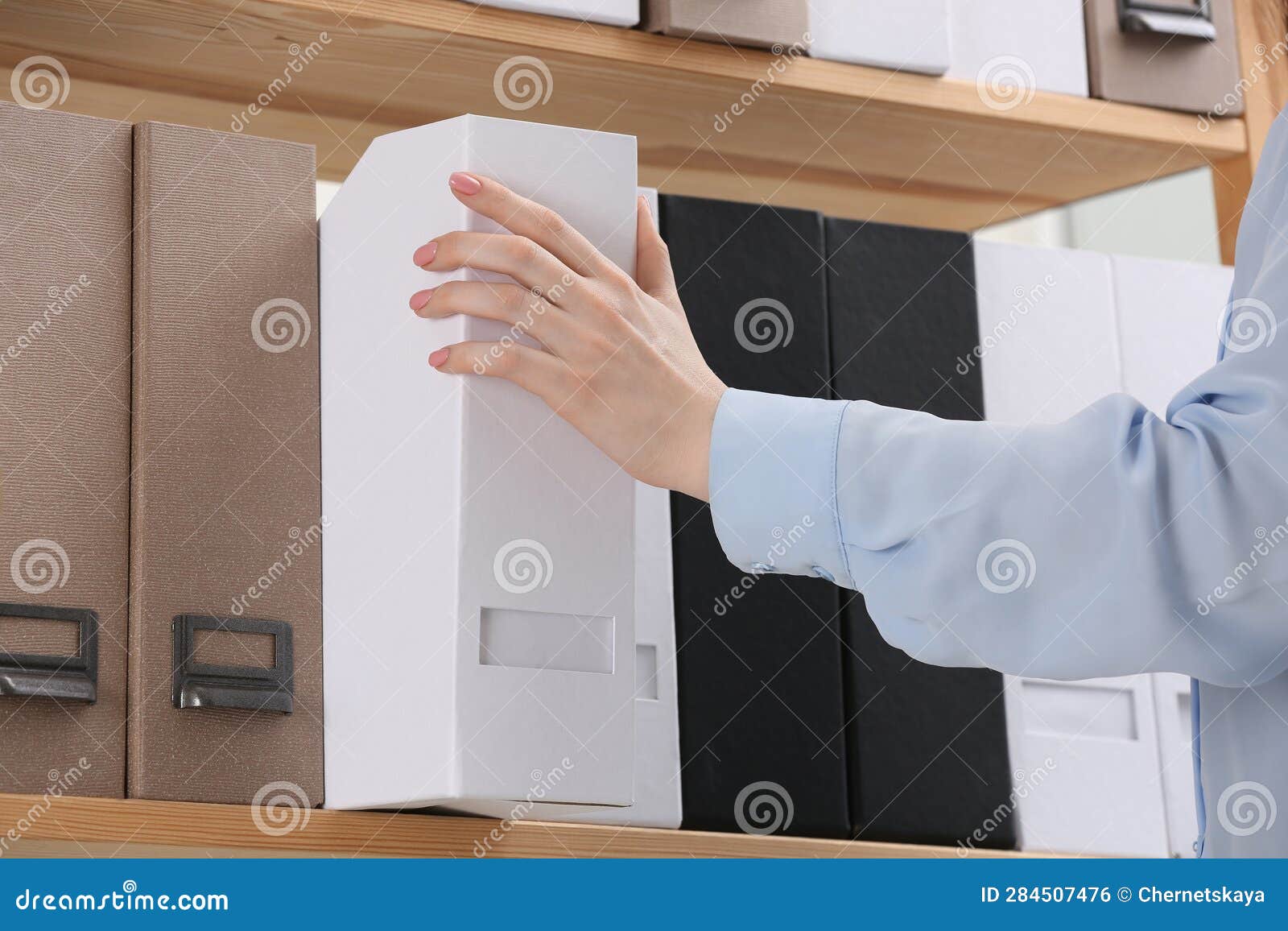 Woman Taking Folder with Documents from Shelf in Office, Closeup Stock ...