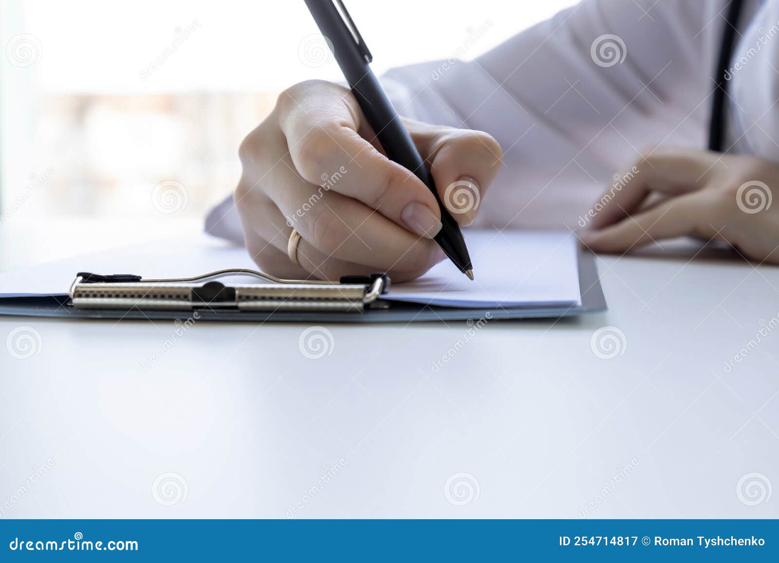 A Woman is Taking Notes. Hand of University Student Using Pen and ...