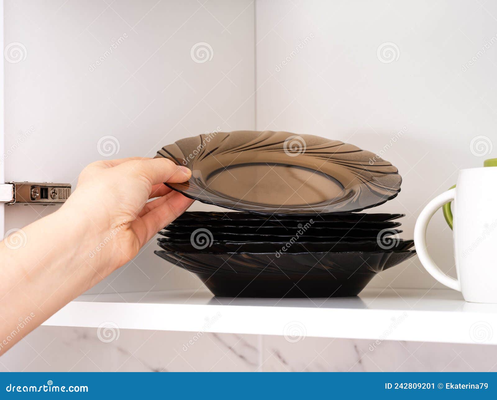 A Woman Taking a Plate from Kitchen Shelf Stock Image - Image of white ...