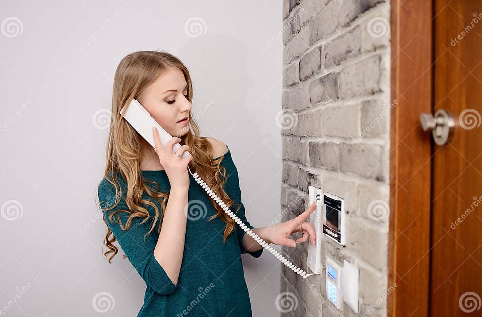 Woman Talking on the Intercom Stock Photo - Image of building, intercom ...
