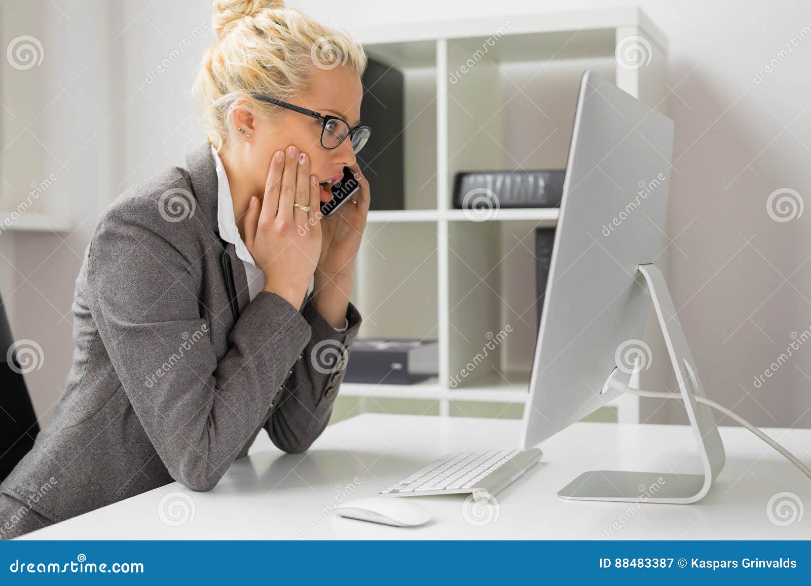 Woman Talking on the Phone and Looking at Computer in Shock Stock Image ...