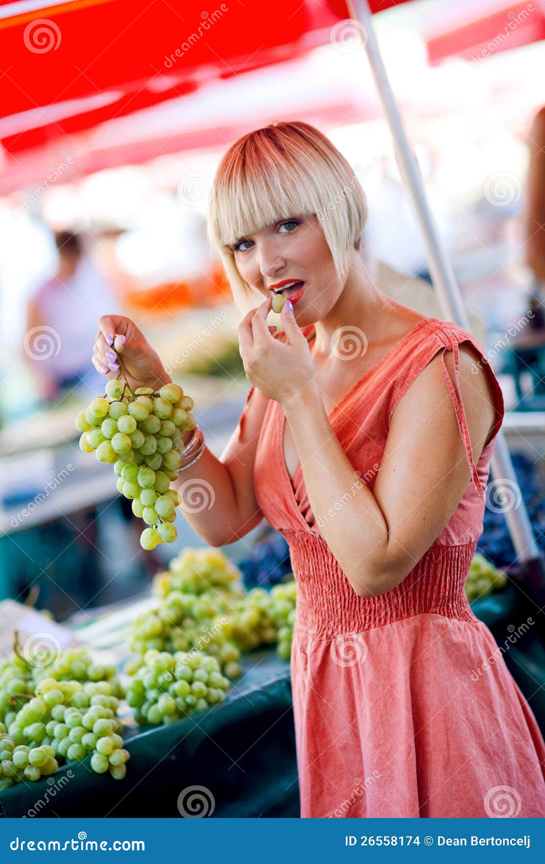 Woman Tasting Grapes in Market Stock Photo - Image of holding ...