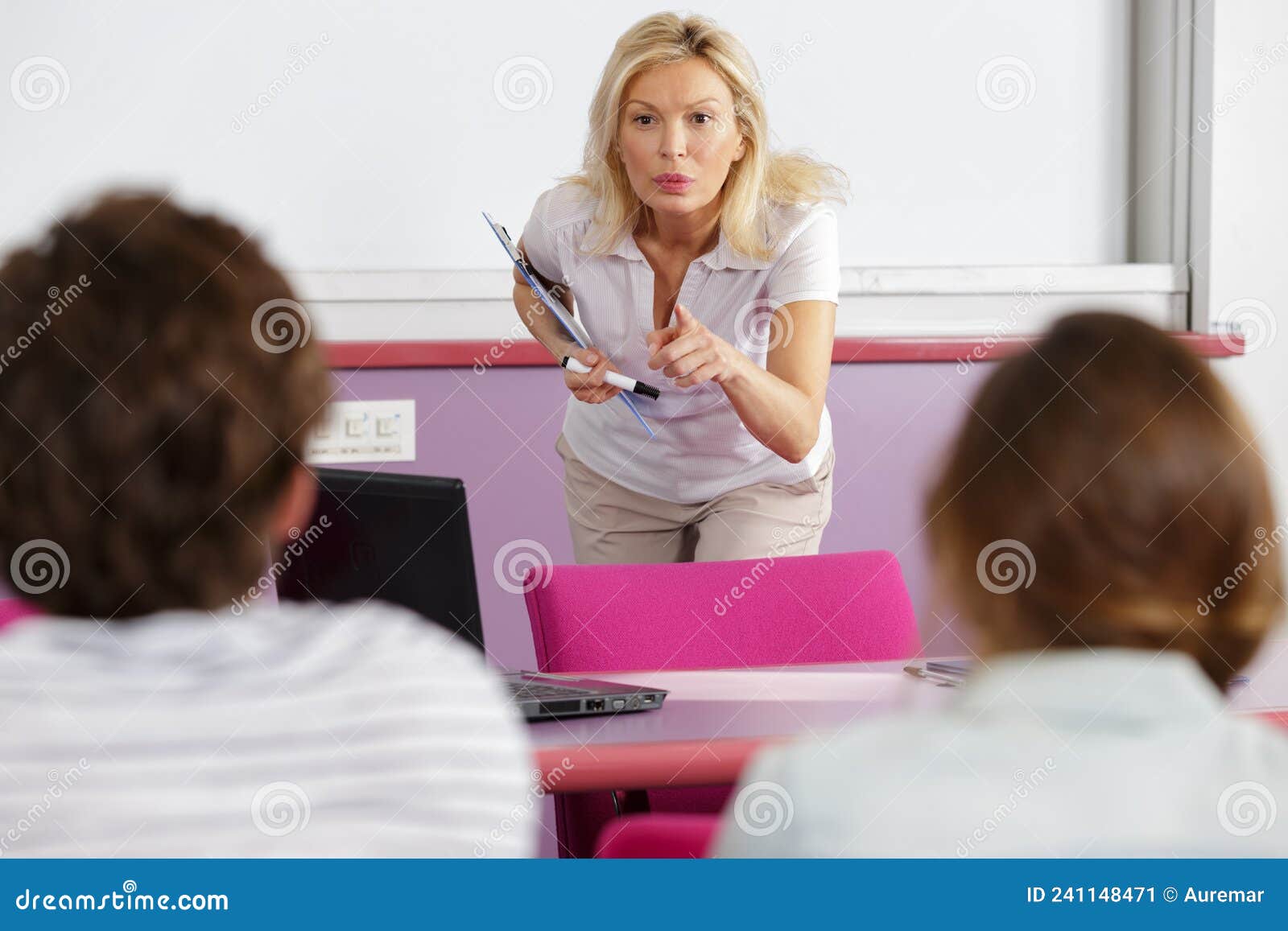 Woman Teacher Addresses Students in Classroom Stock Image - Image of ...