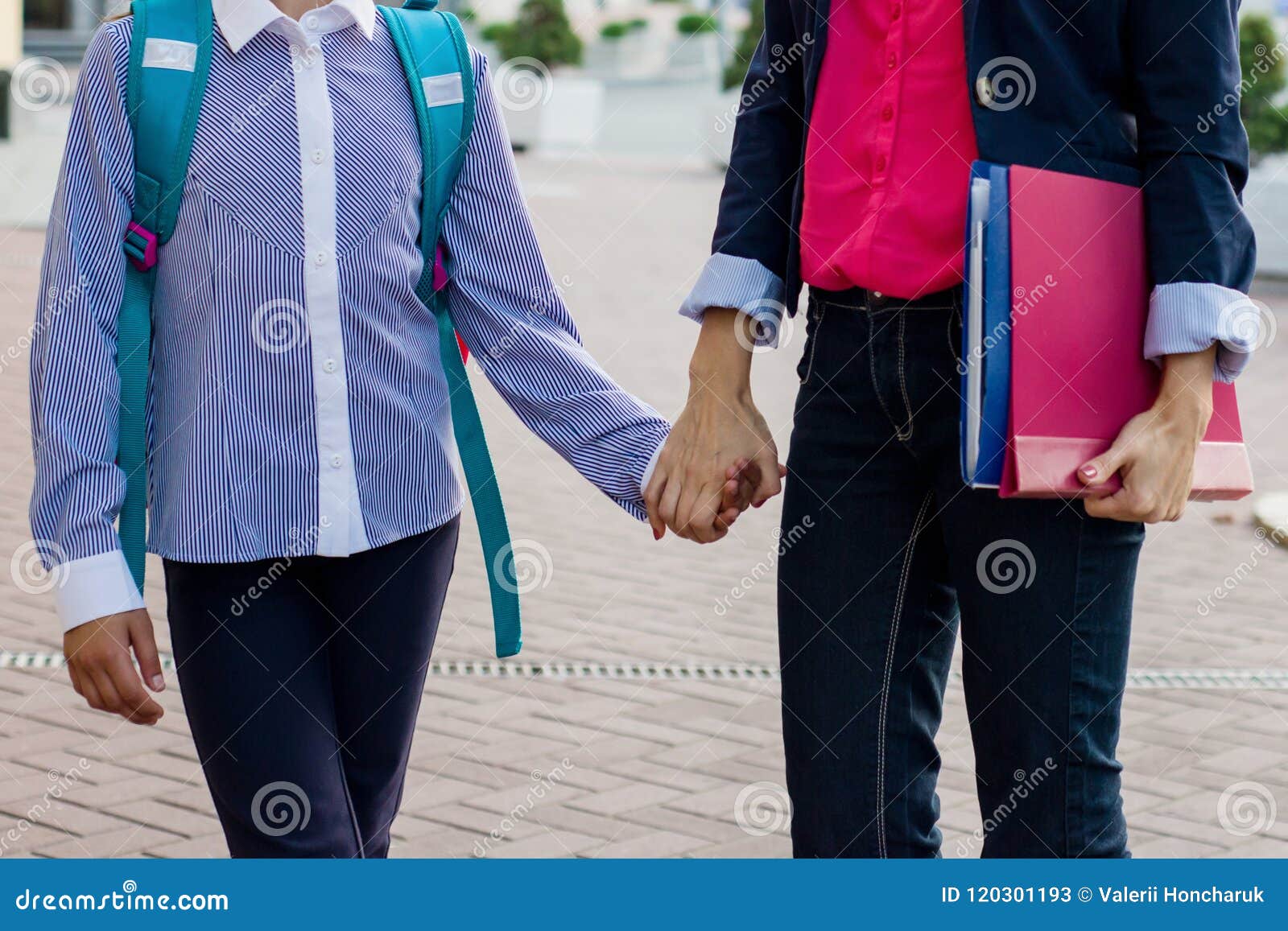 Woman Teacher and Girl Student Holding Hands, Outdoor Background. Stock ... Woman Teacher and Girl Student Holding Hands, Outdoor Background. Stock ...
