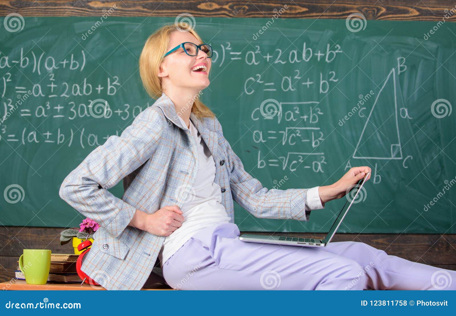 Woman Teacher Hold Laptop Sit Table Classroom Chalkboard Background ... Woman Teacher Hold Laptop Sit Table Classroom Chalkboard Background ...
