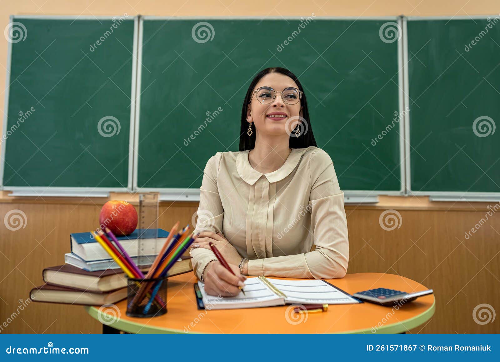 Woman Teacher Sits at a Table with Books and Notebooks Stock Image ...
