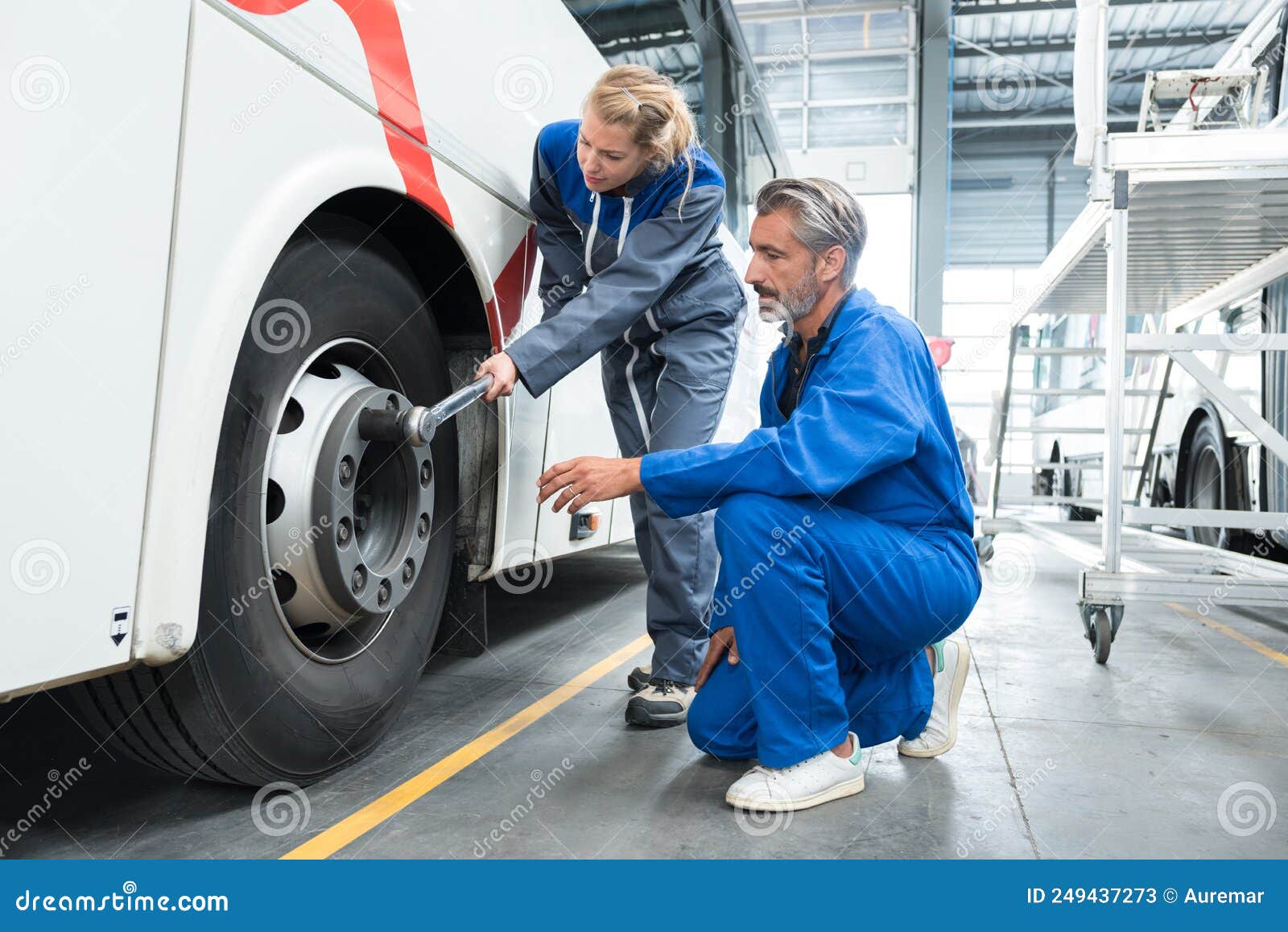 Woman Technician Working with Wheel in Bus Stock Image - Image of ...