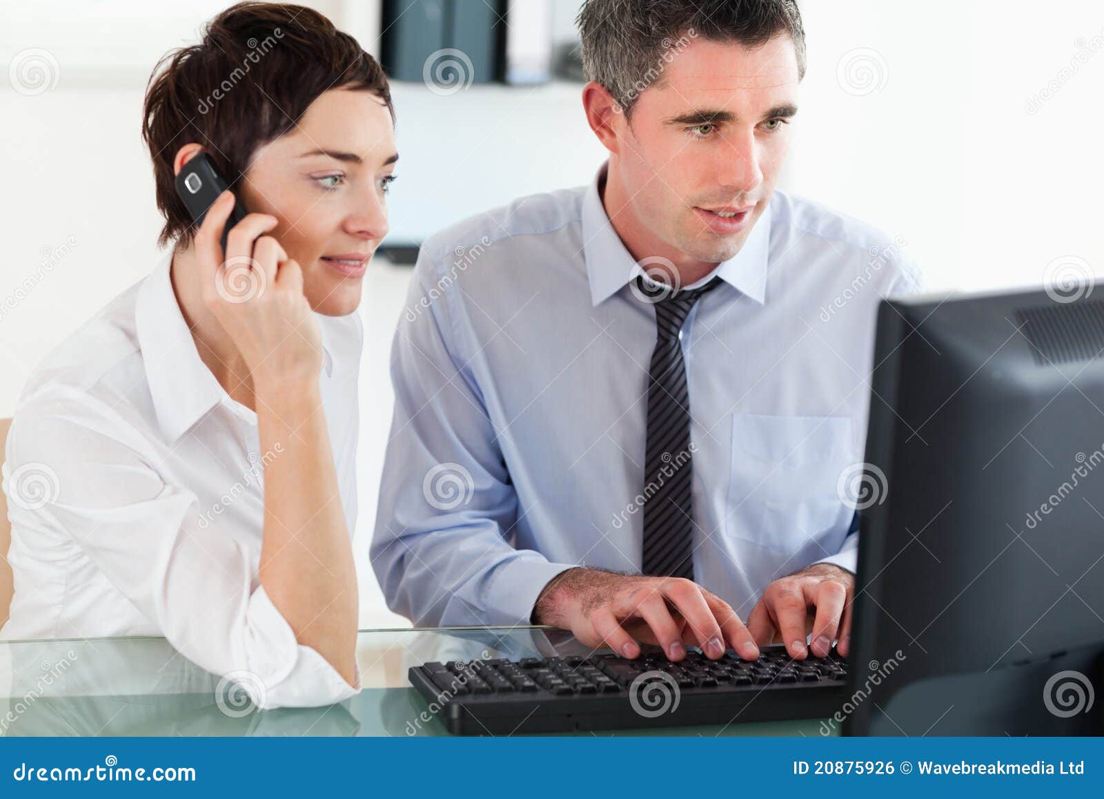 Woman Telephoning while Her Colleague Stock Photo - Image of computer ...