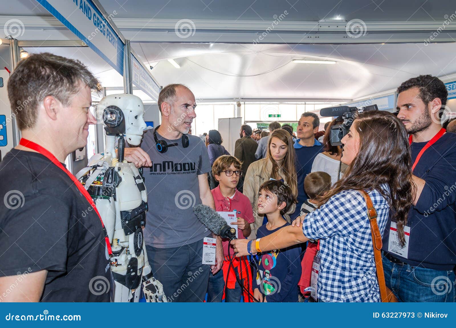 A Woman Television Journalist Interviews with the Microphone at the ...