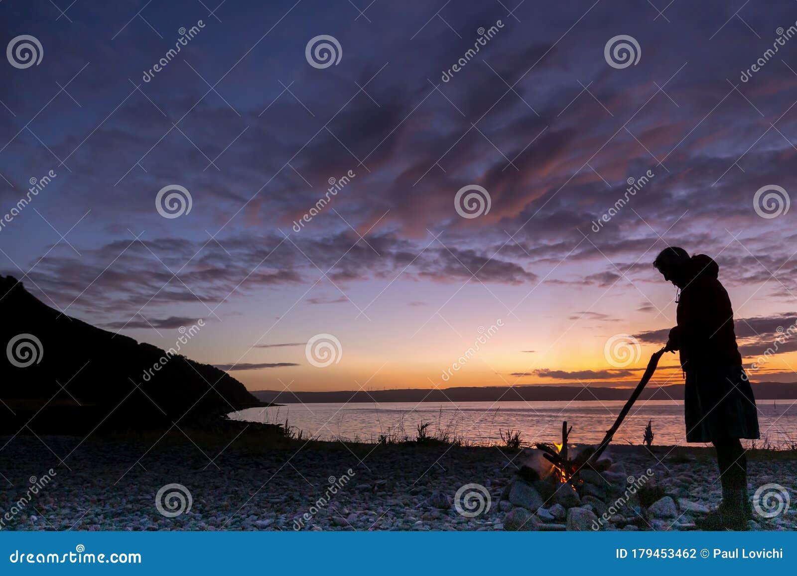 Woman Tending Fire on Arran Stock Photo - Image of camping, coastal ...