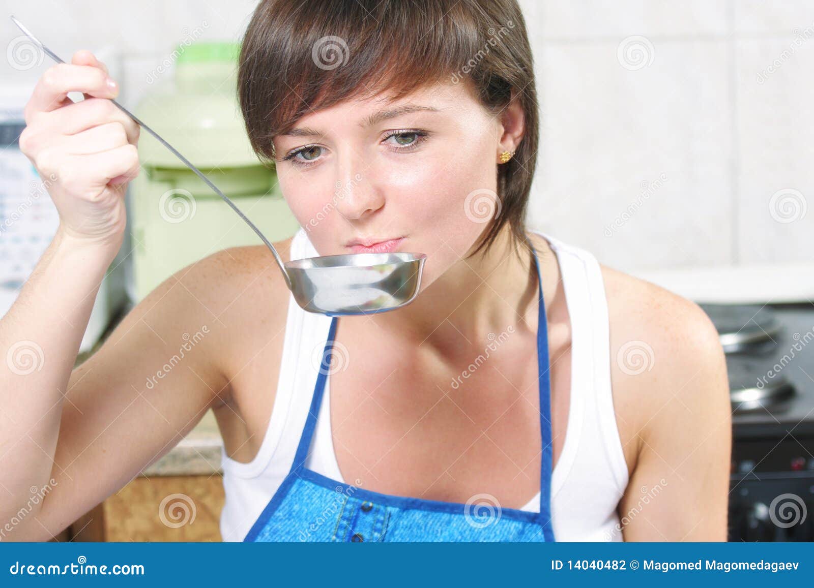 Woman testing food stock photo. Image of apron, brunette - 14040482