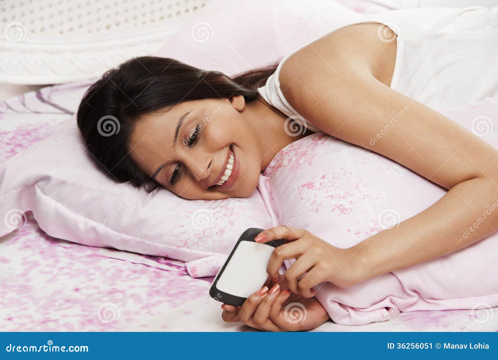 Woman Text Messaging on a Mobile Phone on the Bed Stock Image - Image ...