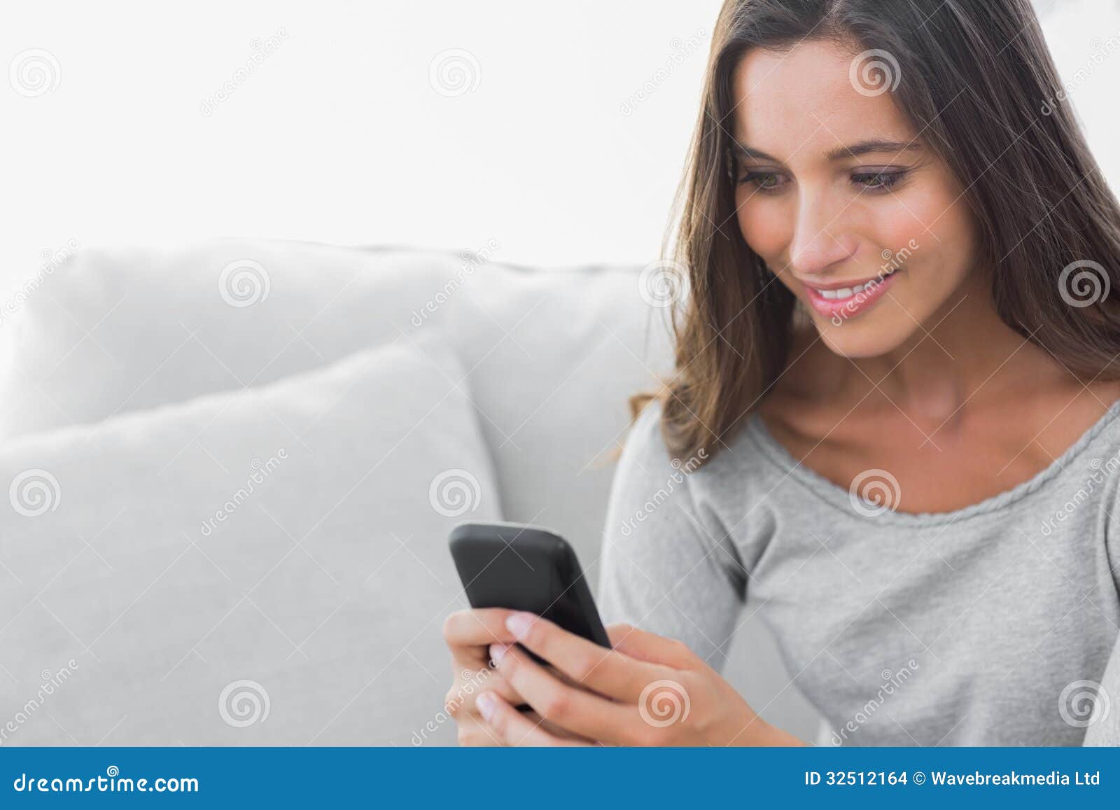 Woman Text Messaging while she is Sat on a Couch Stock Photo - Image of ...