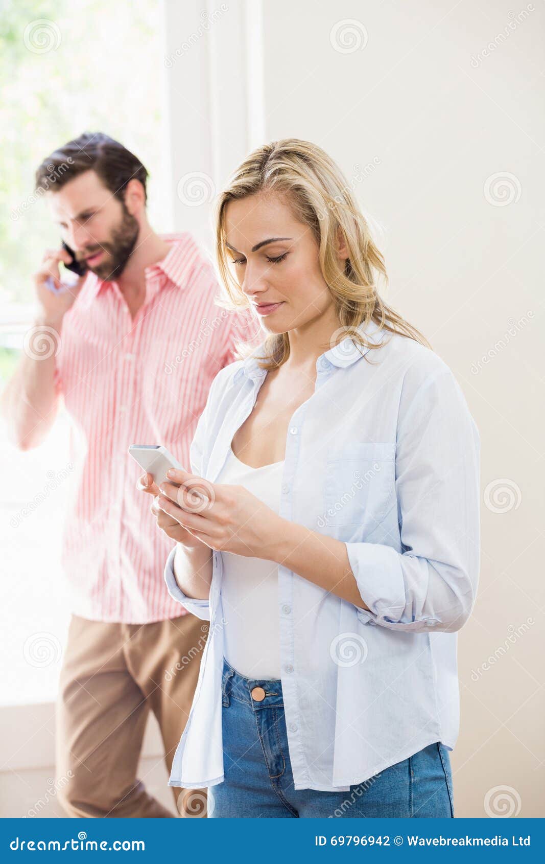 Woman Texting Messaging while Man Talking on Mobile Phone Stock Photo ...
