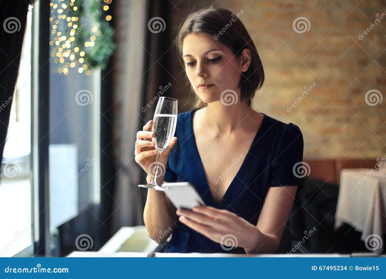 Woman Texting in a Restaurant Stock Photo - Image of lady, table: 67495234