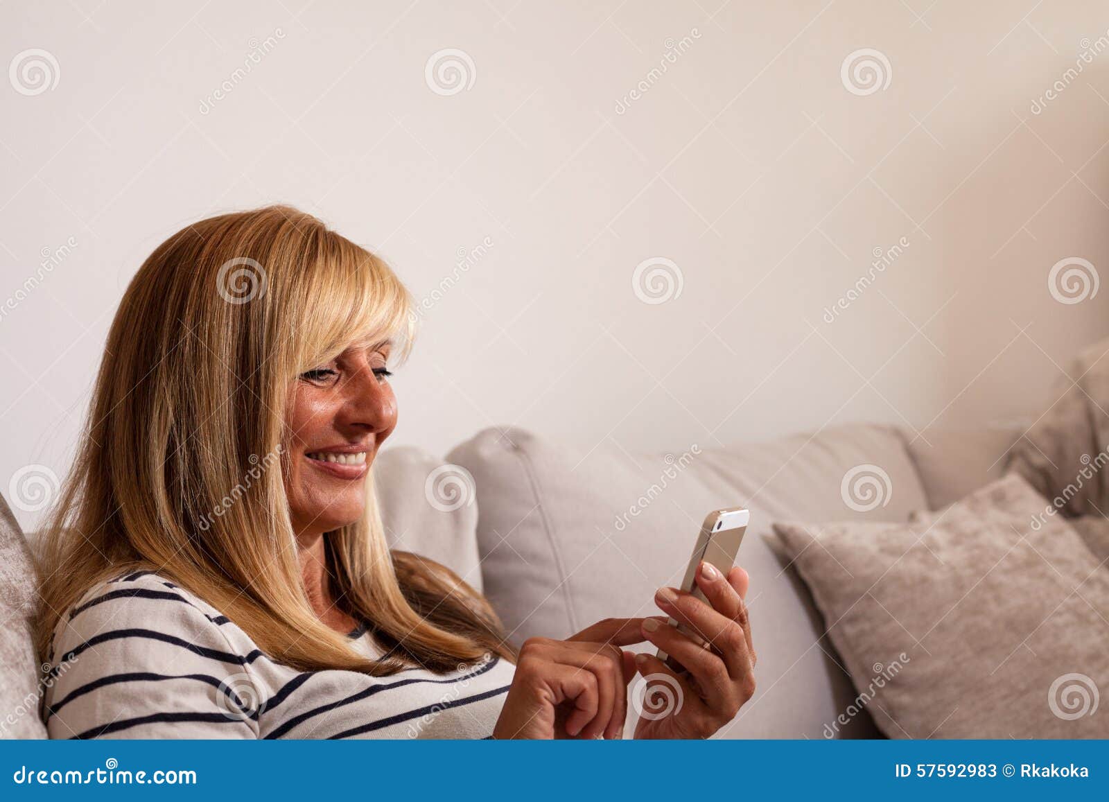 Woman Texting on the Sofa stock image. Image of portrait - 57592983