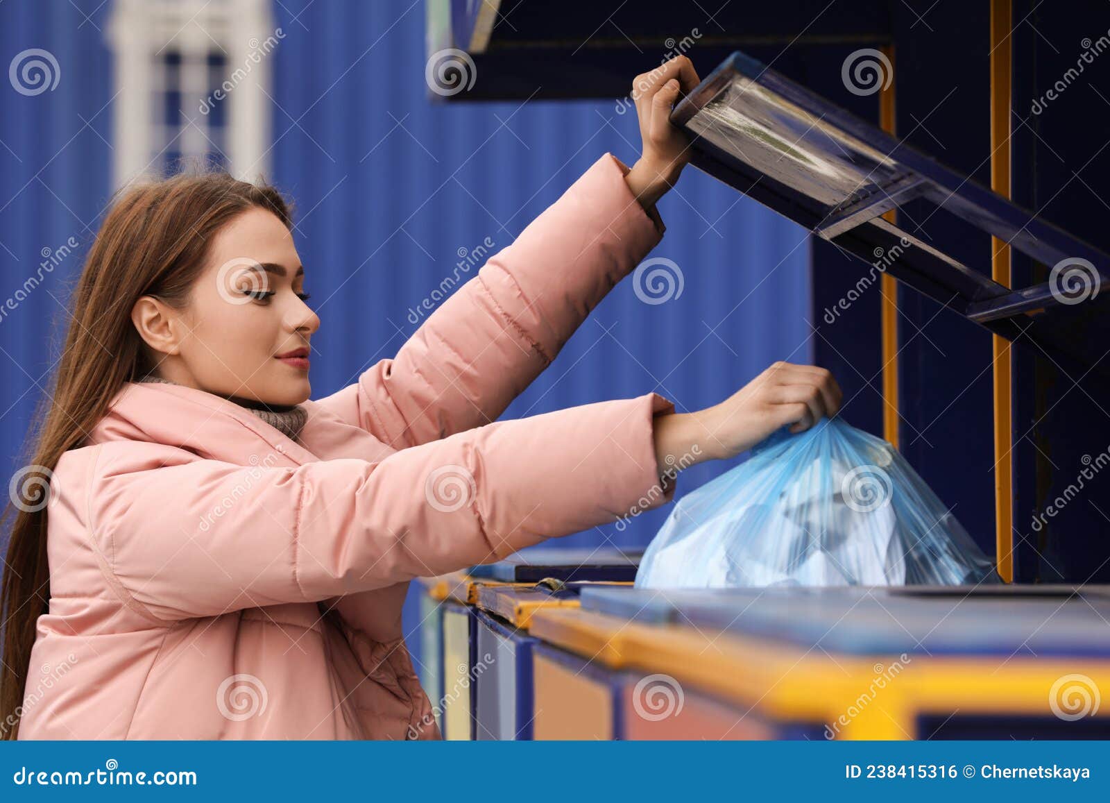 Woman Throwing Garbage into Bin at Recycling Point Outdoors Stock Photo ...