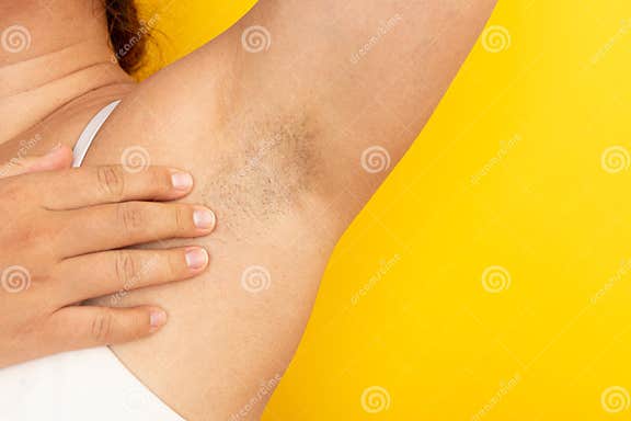 Woman Touch Hairy Underarms With Hand Closeup Free Copy Space Yellow