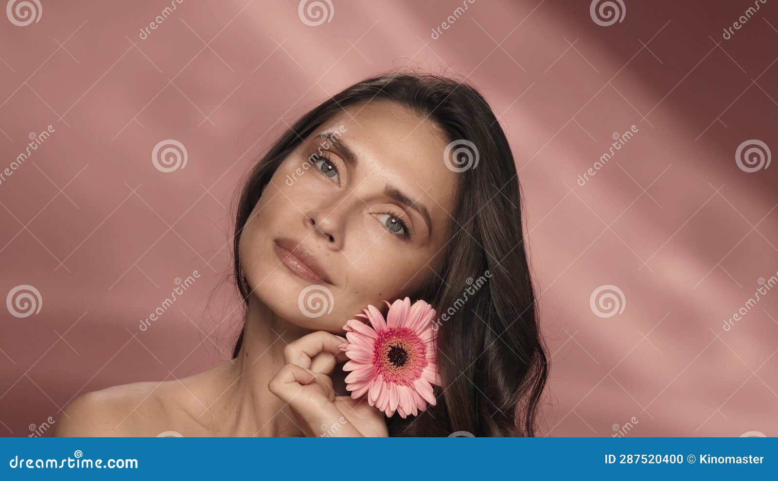 A Woman Touches A Gerbera Flower To Her Perfect Skin Of Face Portrait