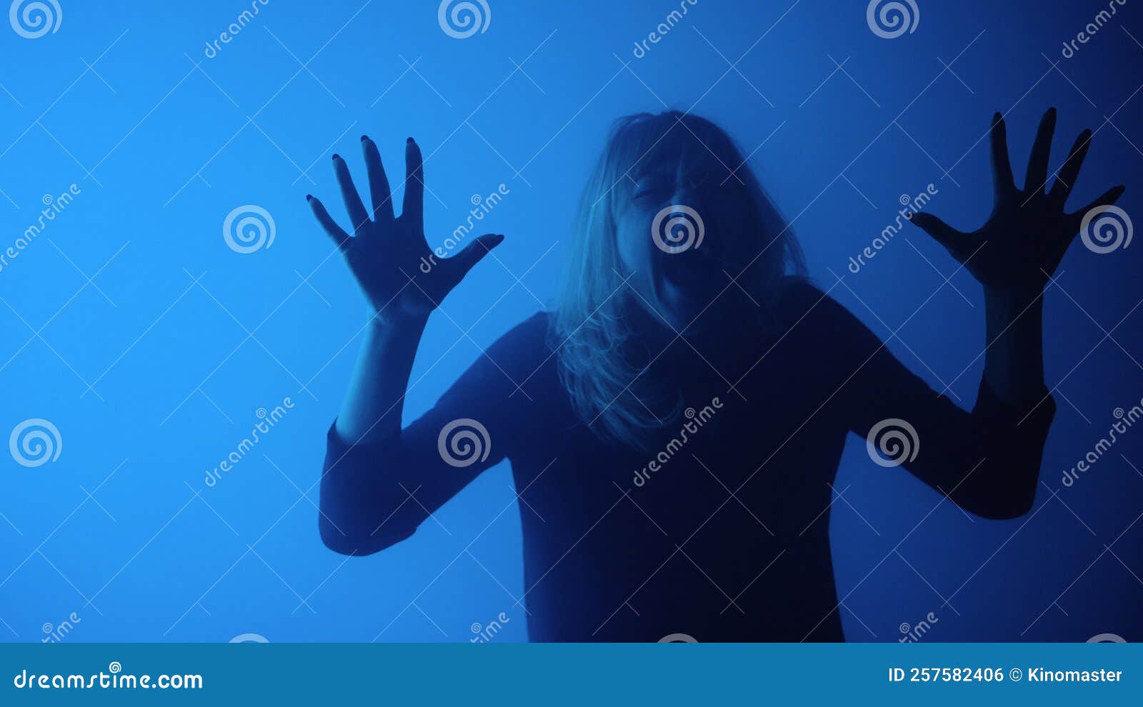 Woman Touches Glass With Palms And And Screams In Fear And Horror