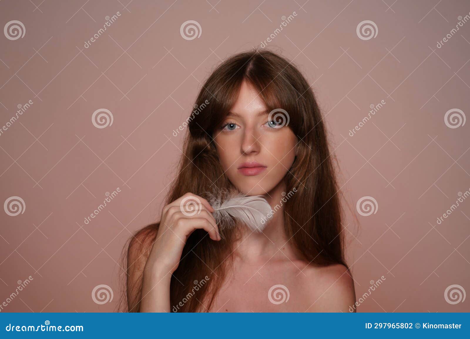 A Woman Touches The Skin Of Her Face With A Feather Portrait Of A