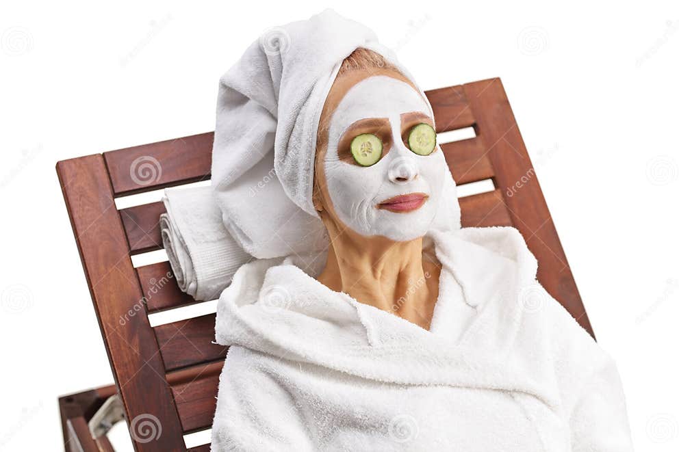 Woman With Towel On Her Head Face Mask And Cucumbers On Eyes Resting