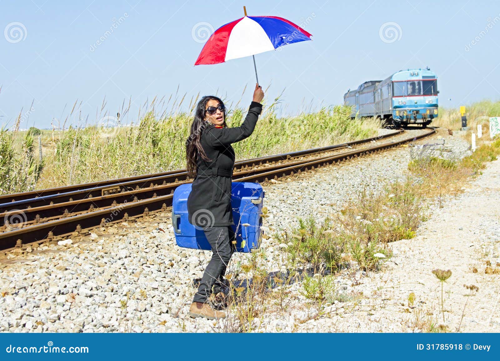 Woman Traveler at a Passing Train Stock Photo - Image of train, paraplu ...