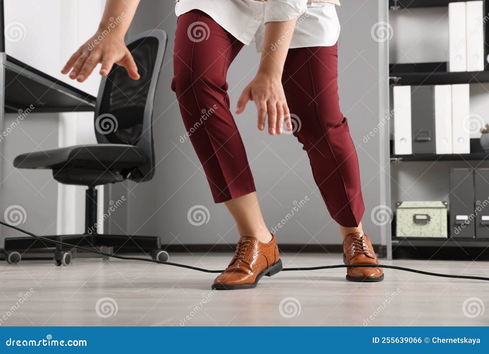 Woman Tripping Over Cable in Office, Closeup Stock Photo - Image of ...