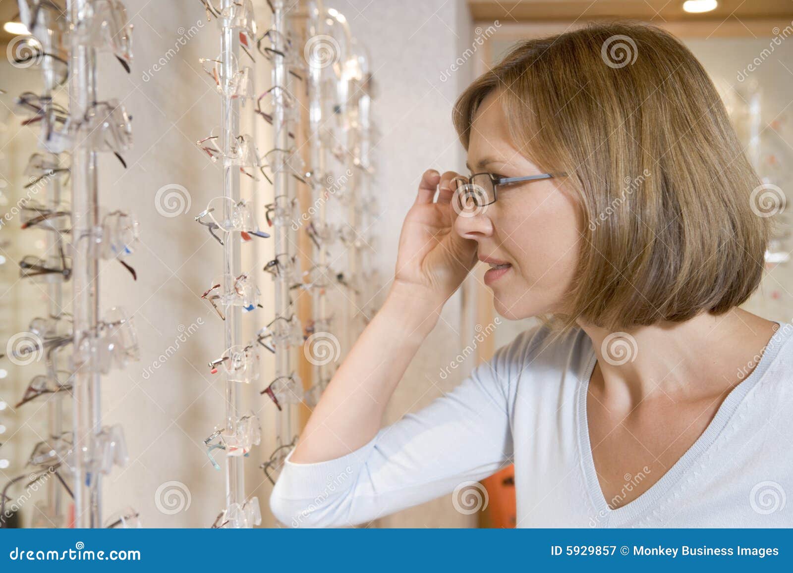 Woman Trying on Eyeglasses at Optometrists Stock Image - Image of ...