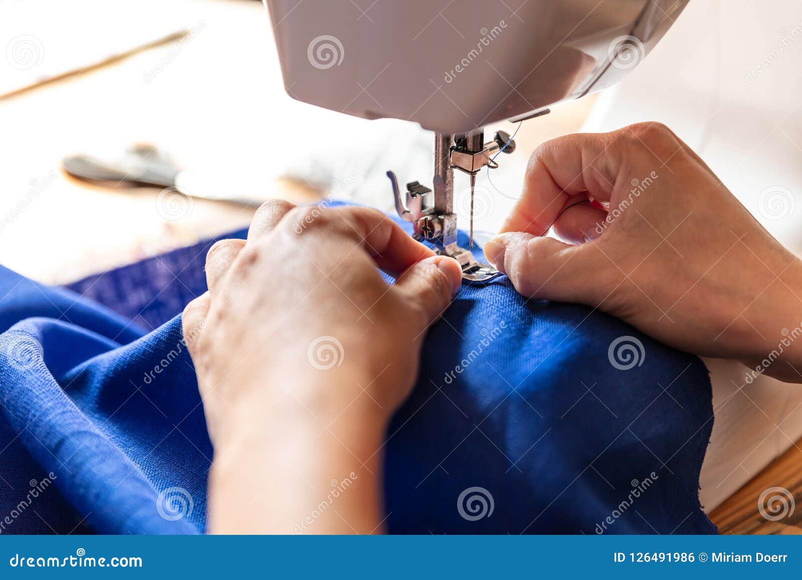 Woman is Trying To Thread a Needle of a Sewing Machine Stock Photo ...